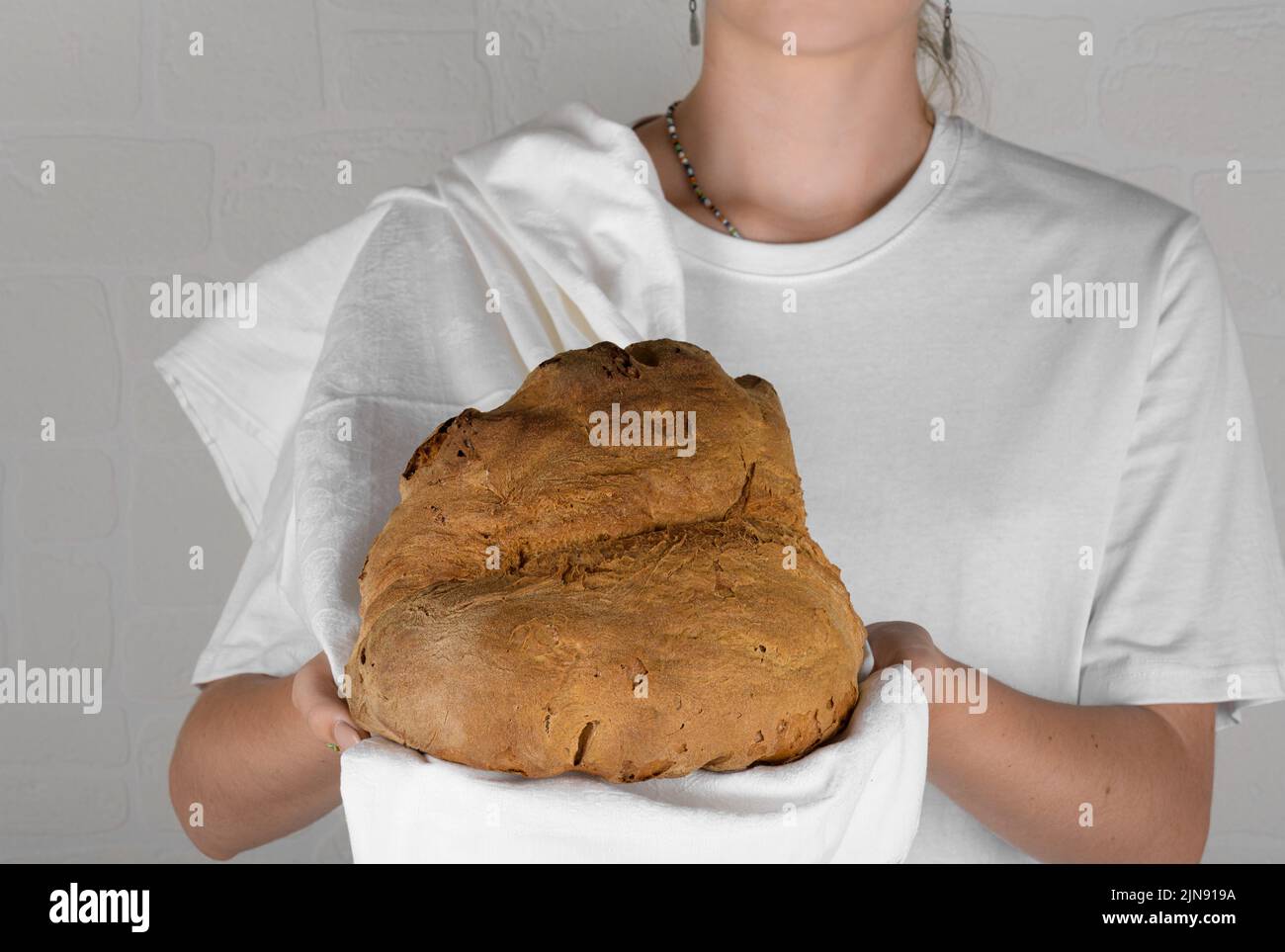 young woman holding the bread of Matera, Pane di Matera on white ...