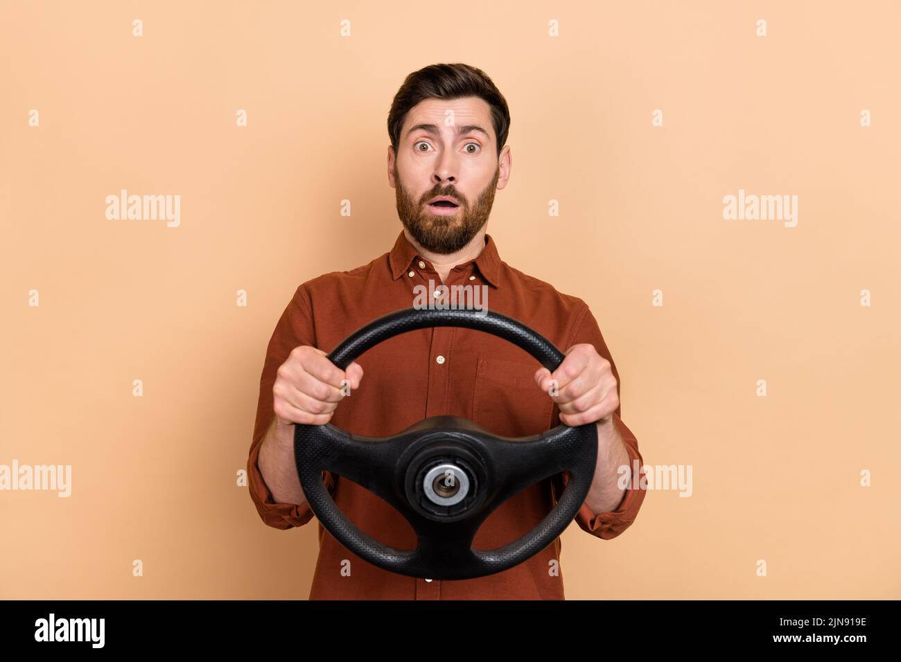 Photo of impressed speechless person hands hold wheel stare cant ...