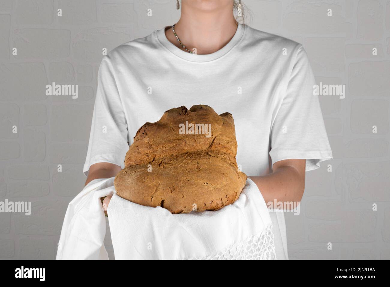 young woman holding the bread of Matera, Pane di Matera on white ...