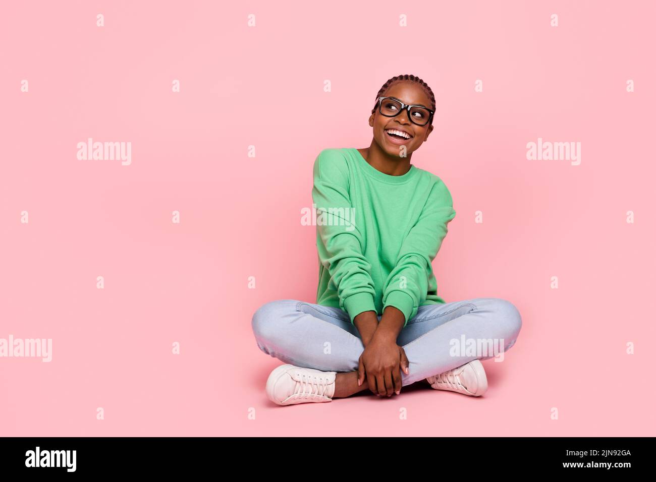 Full length photo of minded cheerful girl sit floor look interested ...