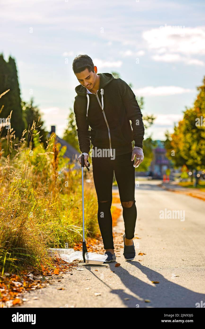 Focused volunteer conserving environment from pollution and plastic ...