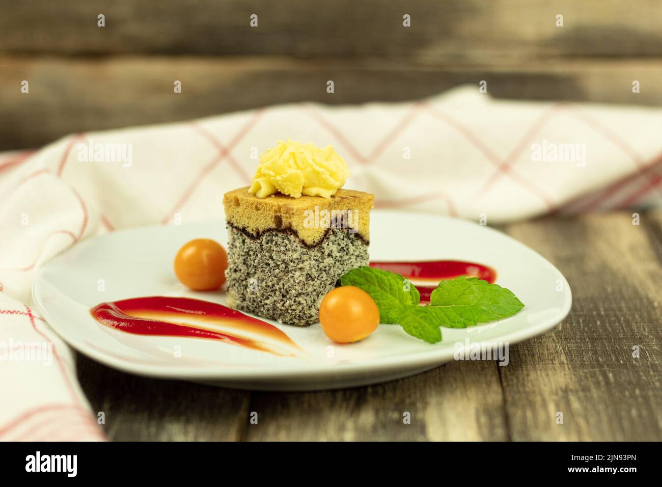 Delicious sponge cake with poppy filling. A piece of cake on a white ...