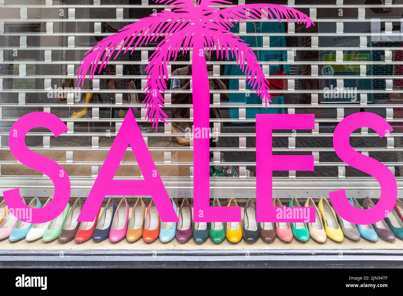 Multicolored ballerinas on display in the window of a shuttered store ...