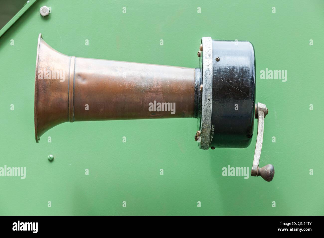 Old manual siren, activated by crank, with copper horn Stock Photo - Alamy