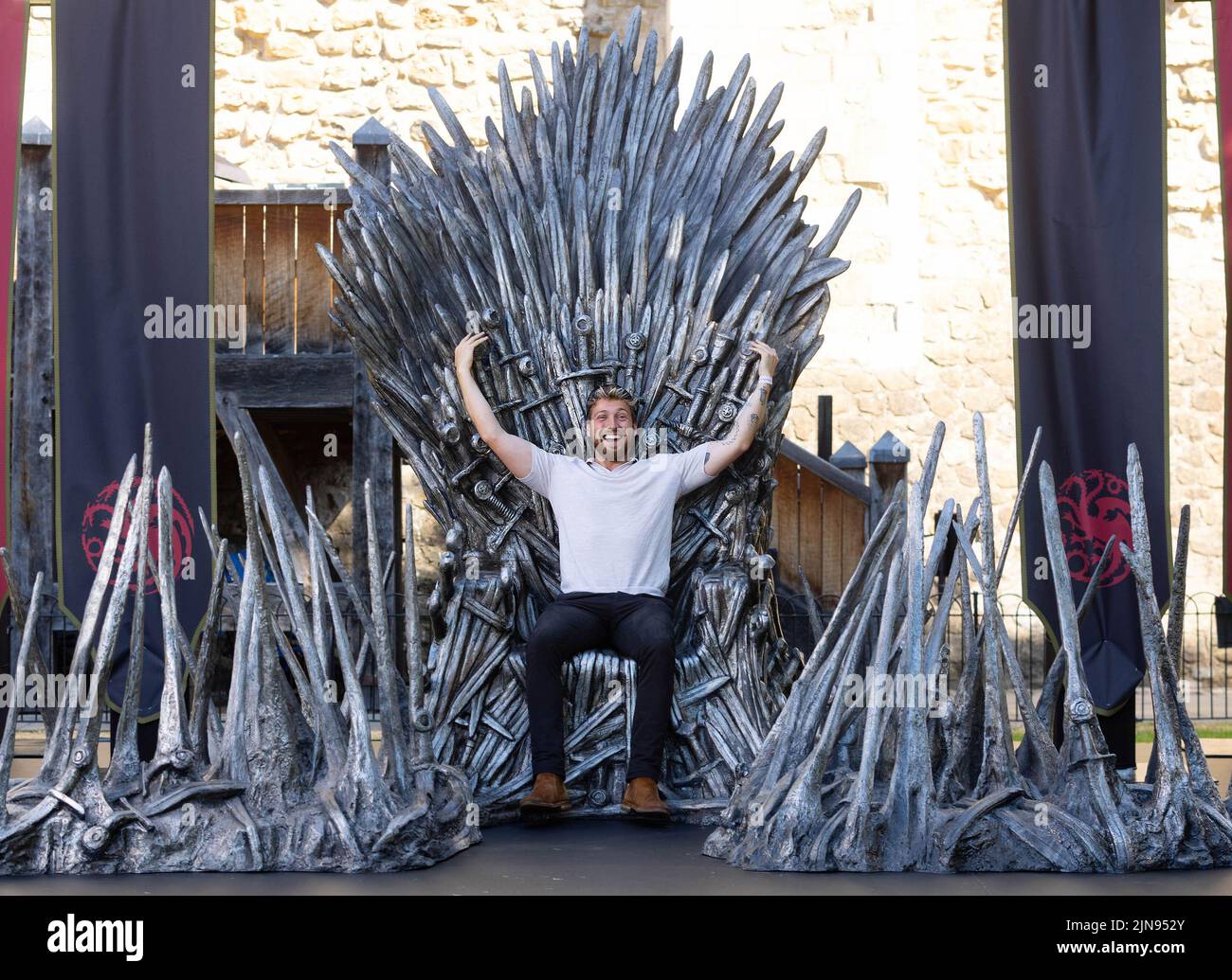 EDITORIAL USE ONLY Reality TV star Sam Thompson sits on the Iron Throne ...