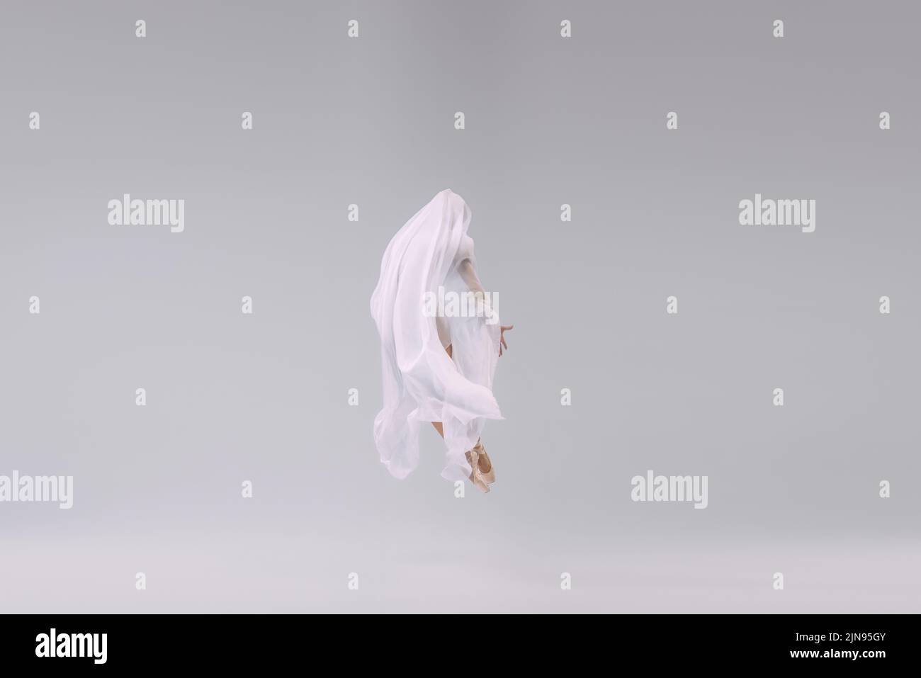 Portrait of young ballerina dancing, jumping fully covered with ...