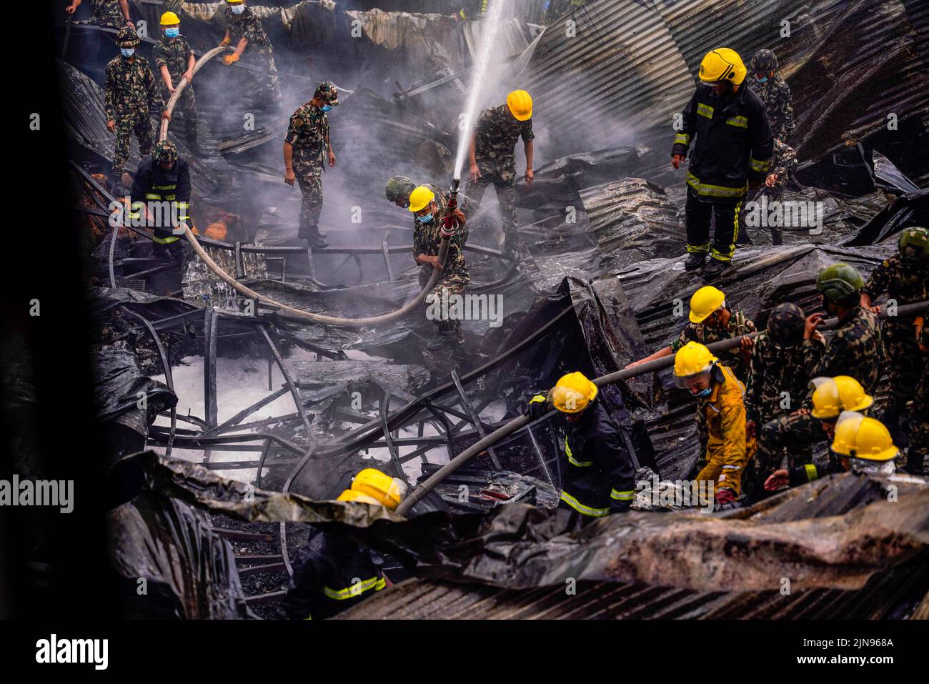 Kathmandu, Nepal. 10th Aug, 2022. Firefighters along with the help of ...