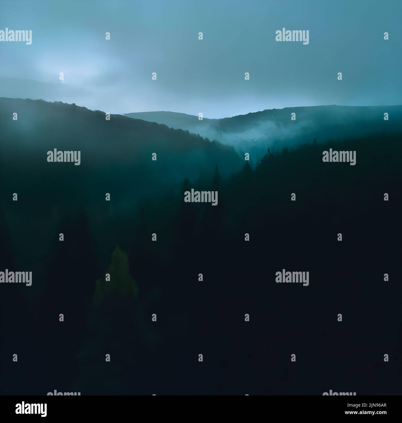 A dramatic landscape of mountains covered in forests and fog under a ...
