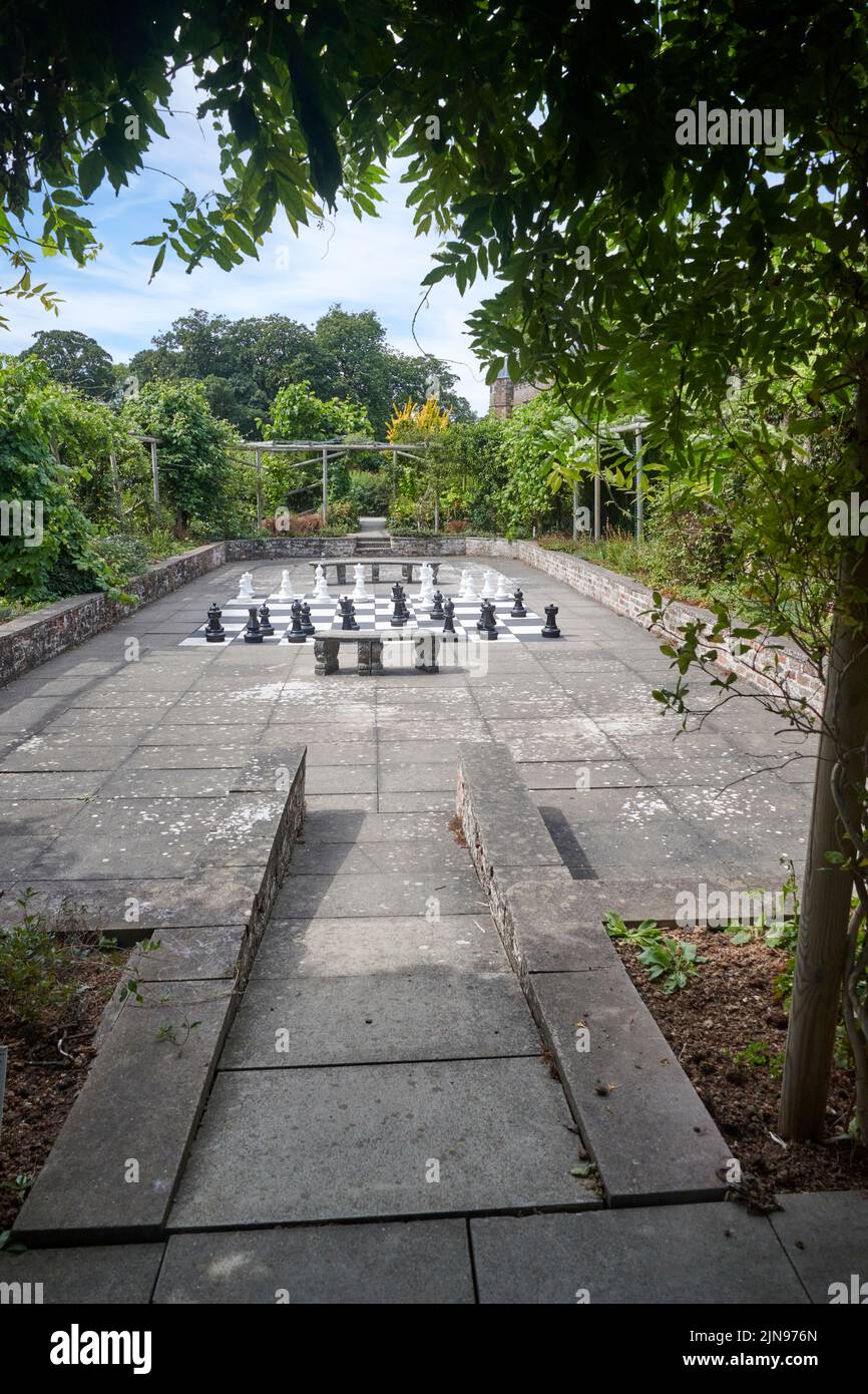 An outdoor giant chess game in a walled garden in the summer in East ...