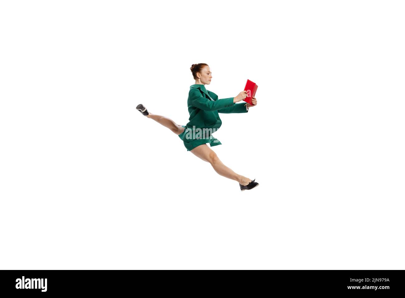 Leap. Stylish young woman in business style outfit in motion isolated ...