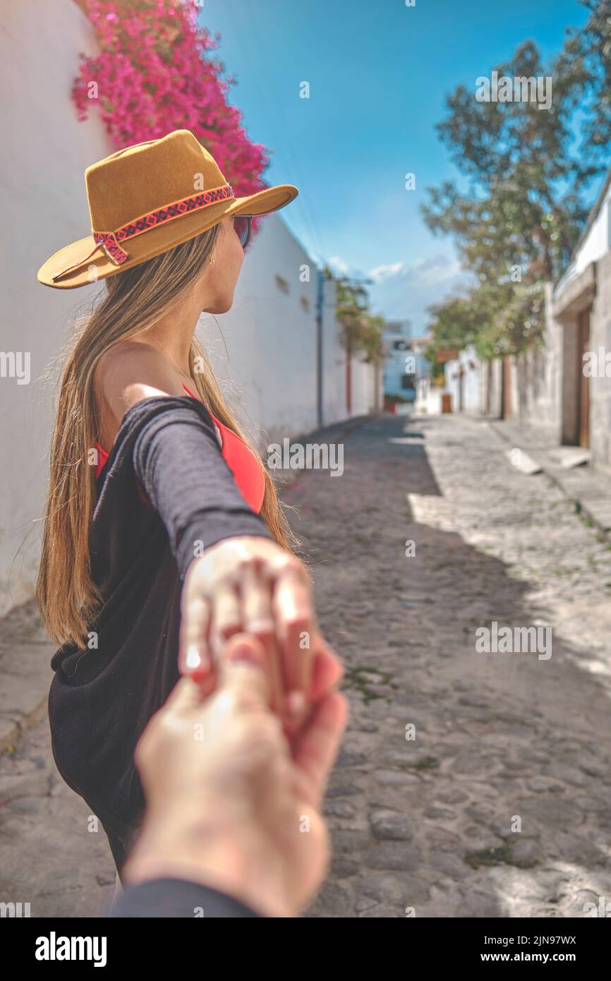 Closeup Young woman holding man hand while leading him on the old ...