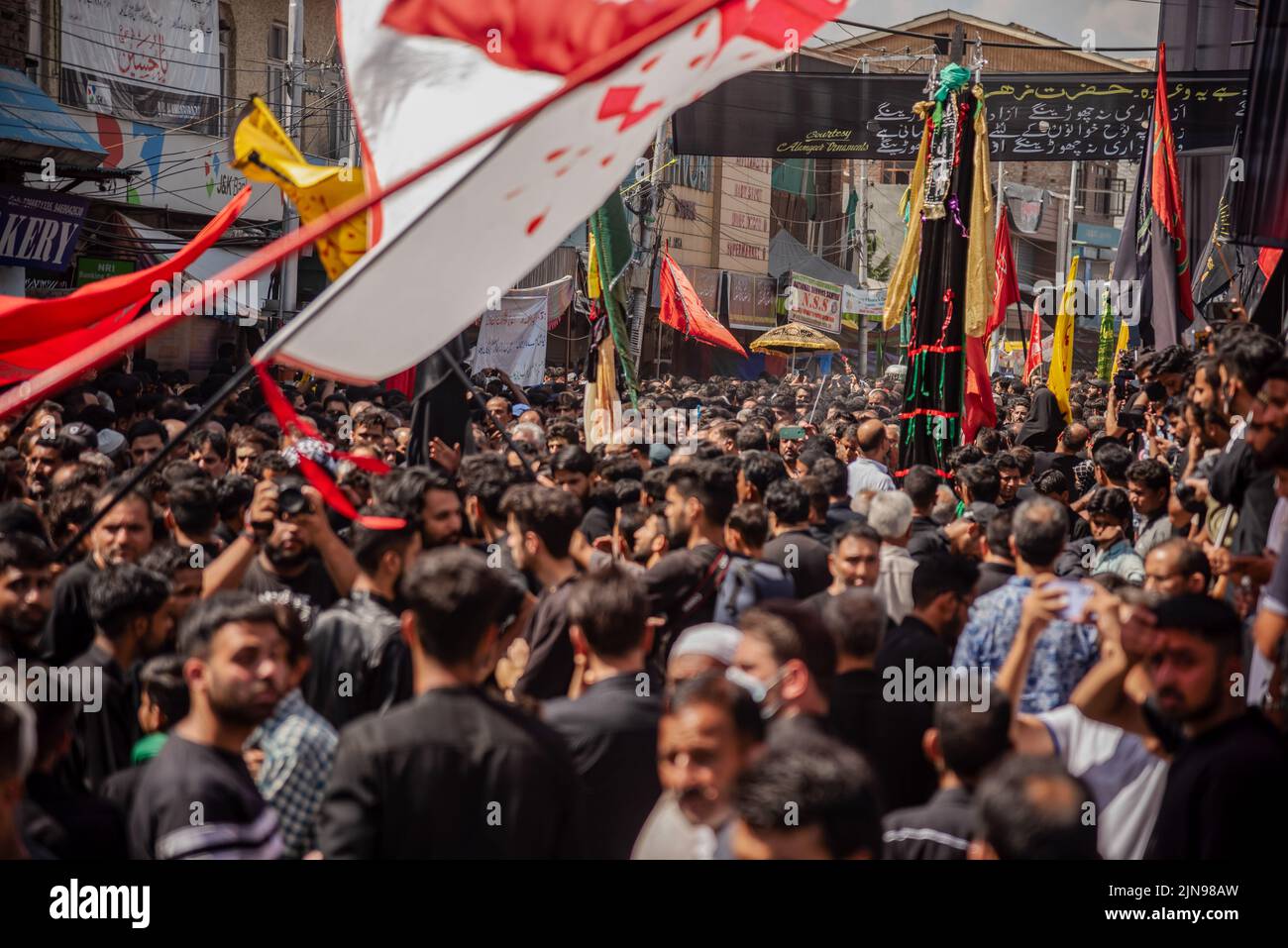 Shia Muslims wave Alam's during an Ashura procession. Ashura is the ...