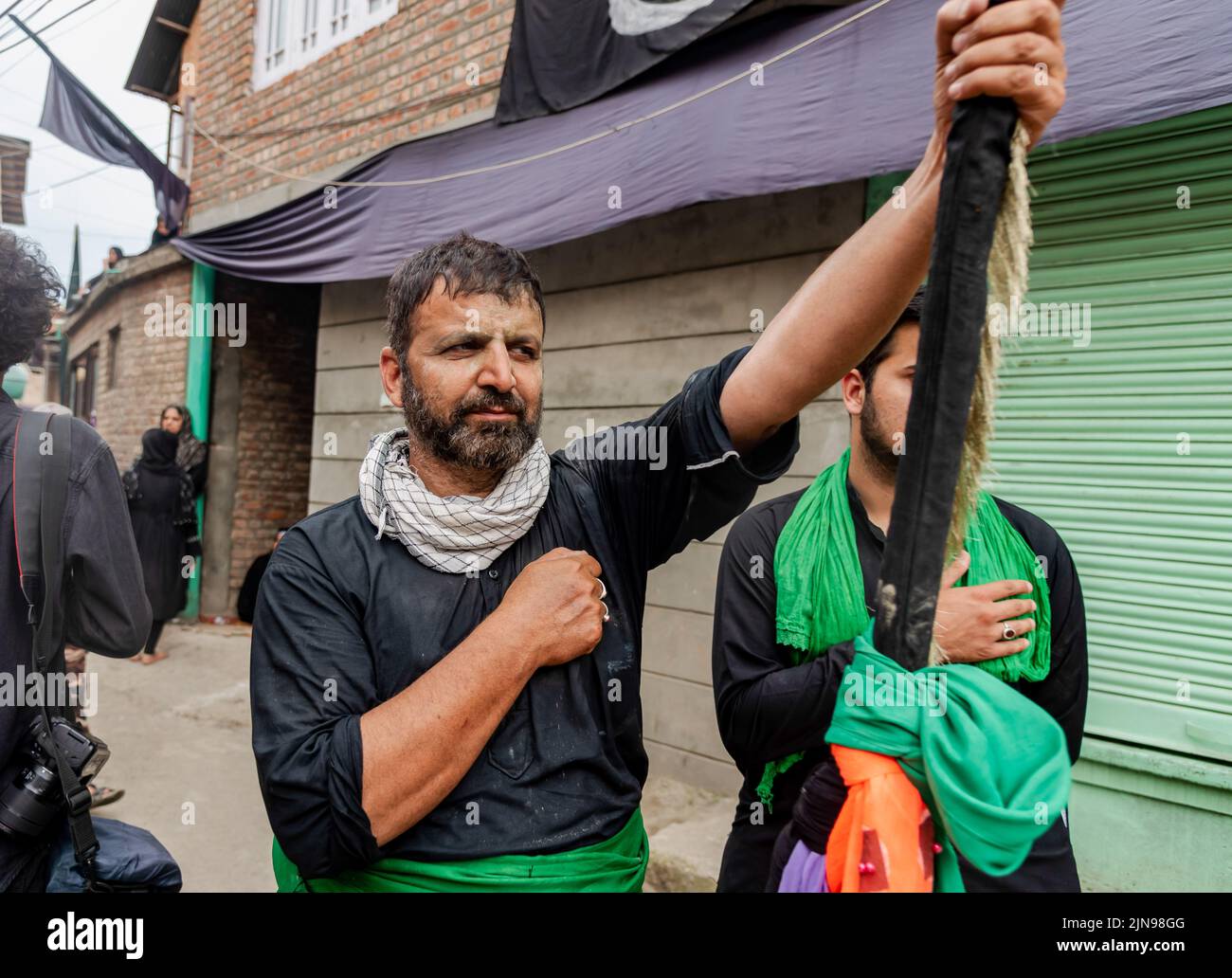 A Shia Muslim man hold an Alam during Ashura Procession. Ashura is the ...