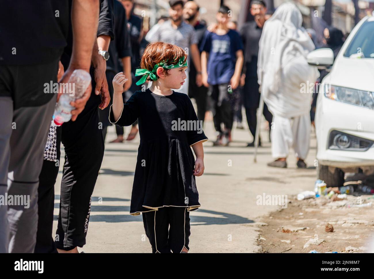 A Shia Muslim girl looks on as she walk during an Ashura procession ...