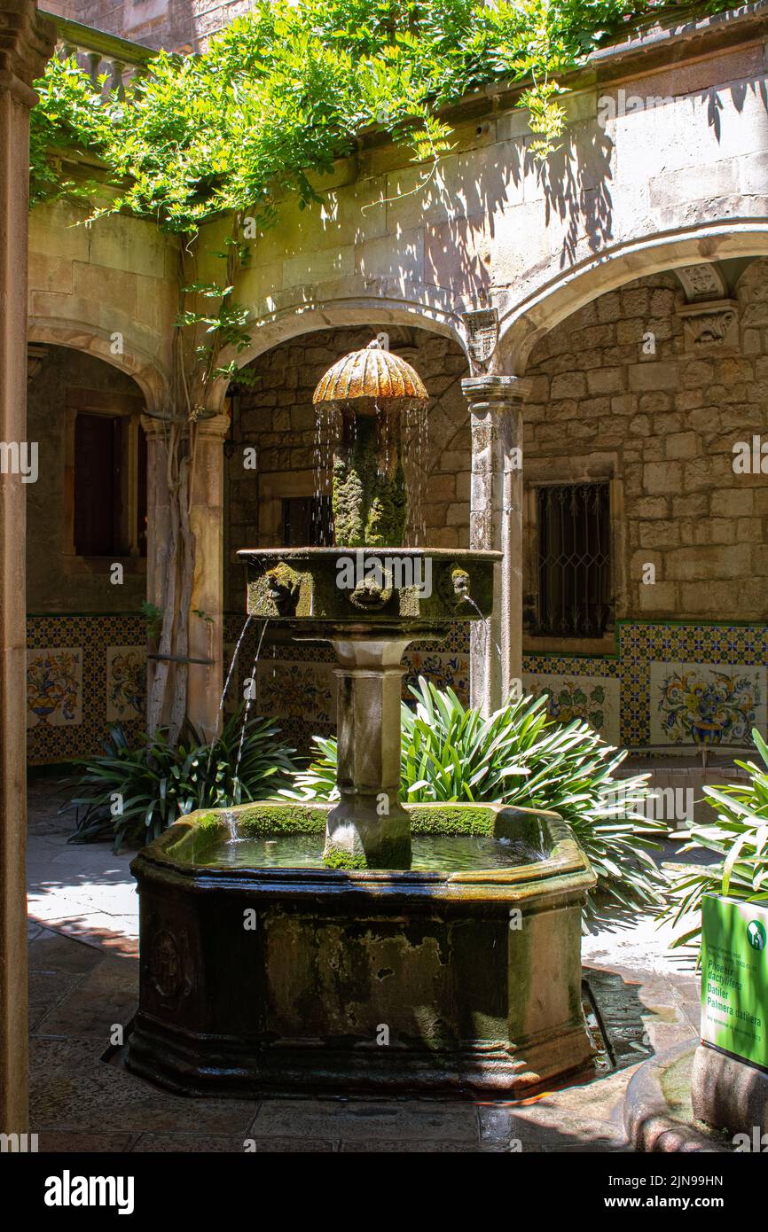 Vertical photo of a very stylish fountains in an exterior courtyard ...