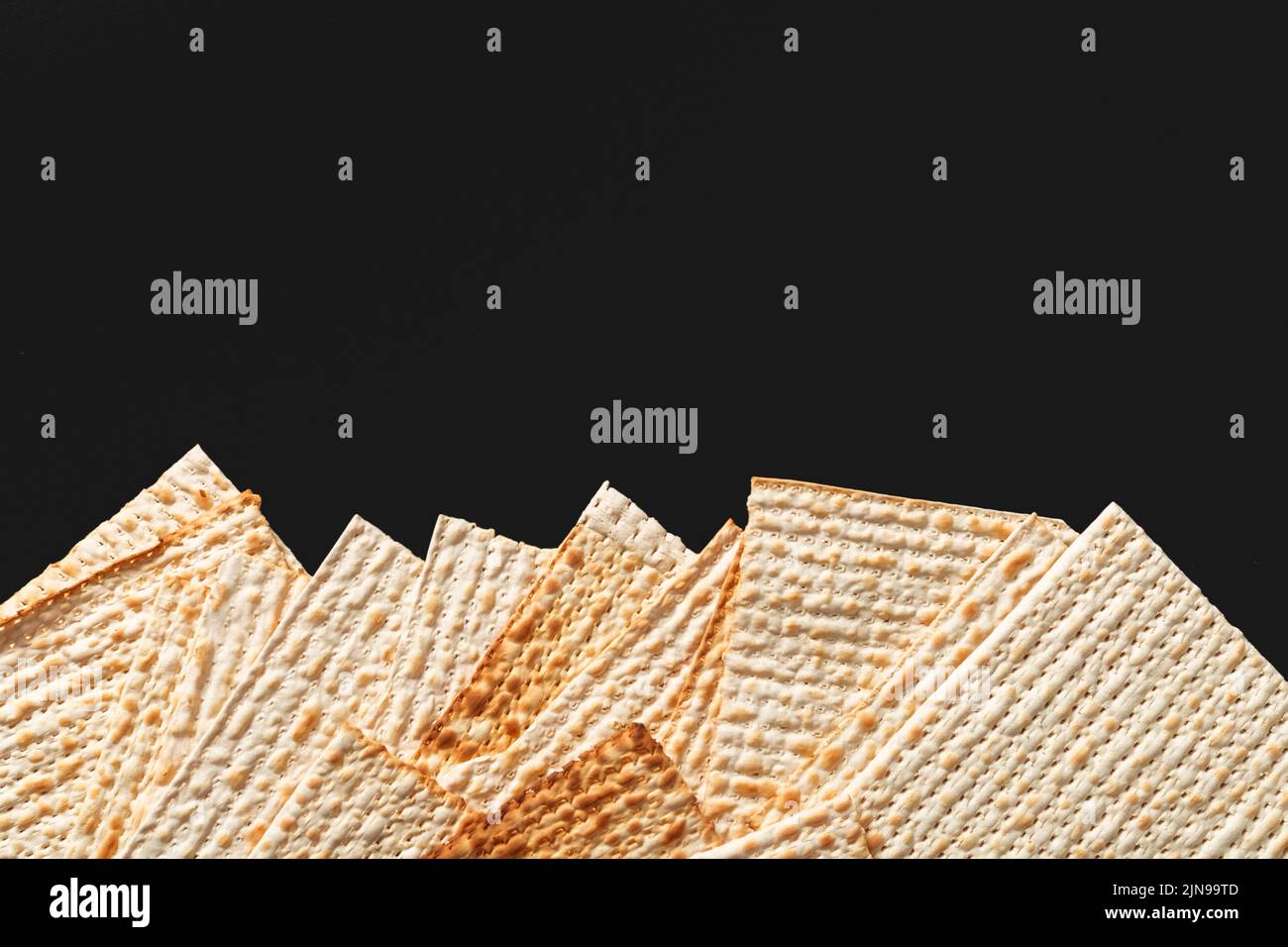 A photo of matzah or matza pieces on black background. Matzah for the ...