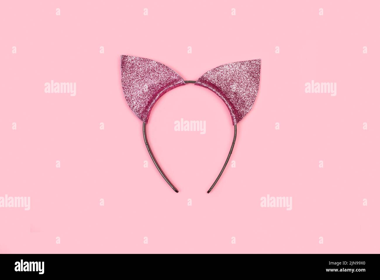 A feline ear shape headband on a pink background with copy space Stock ...