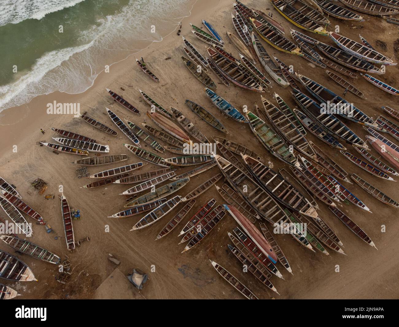 Aerial photo of many docked fishing vessels on the sand in the Port de ...