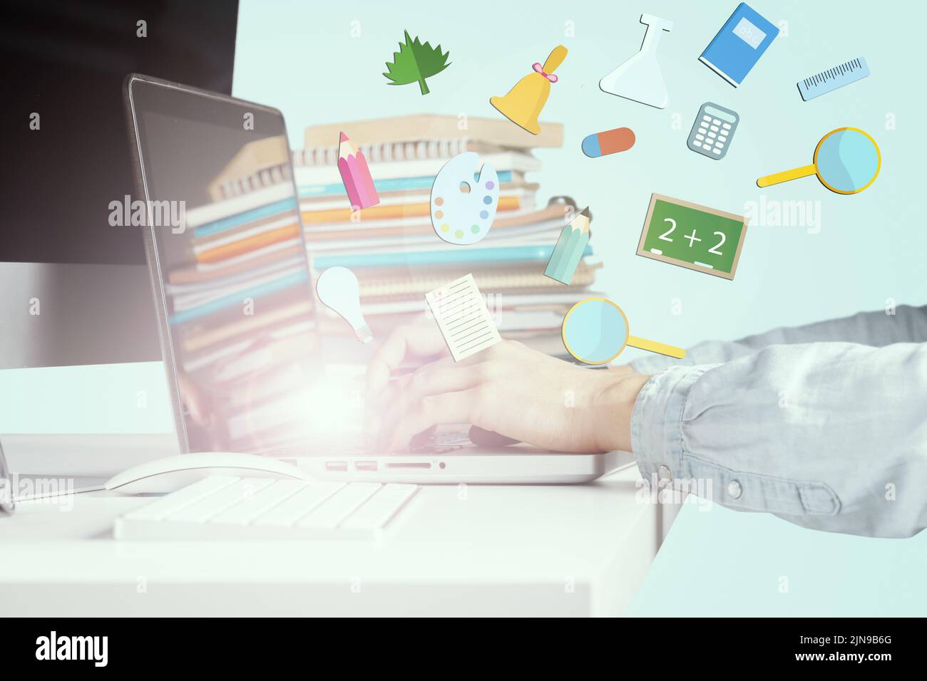 Young woman sitting at the table with open netbook computer. Female ...