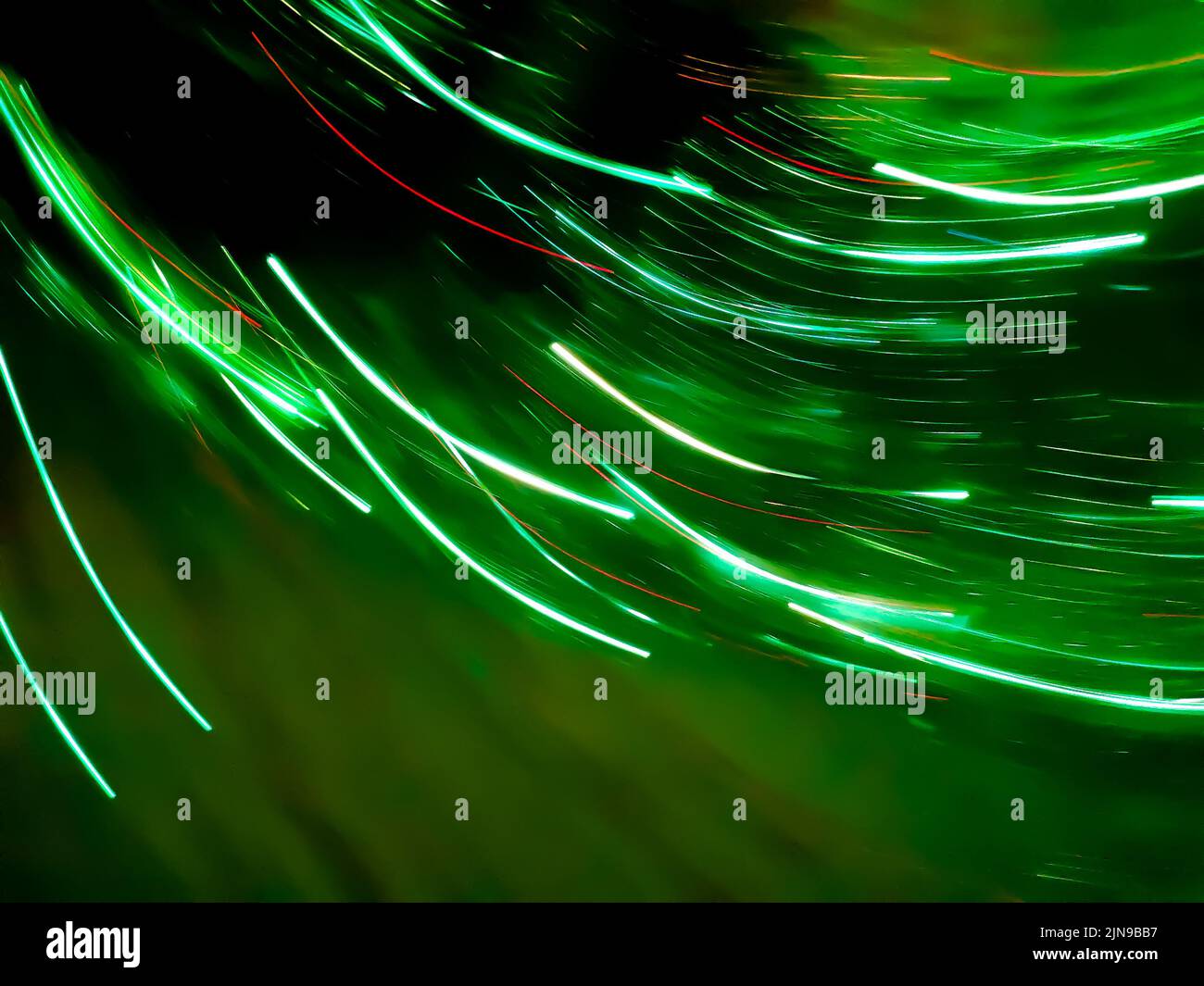 Abstract green light trail vortex. Lights moving in circular green pattern Stock Photo - Alamy