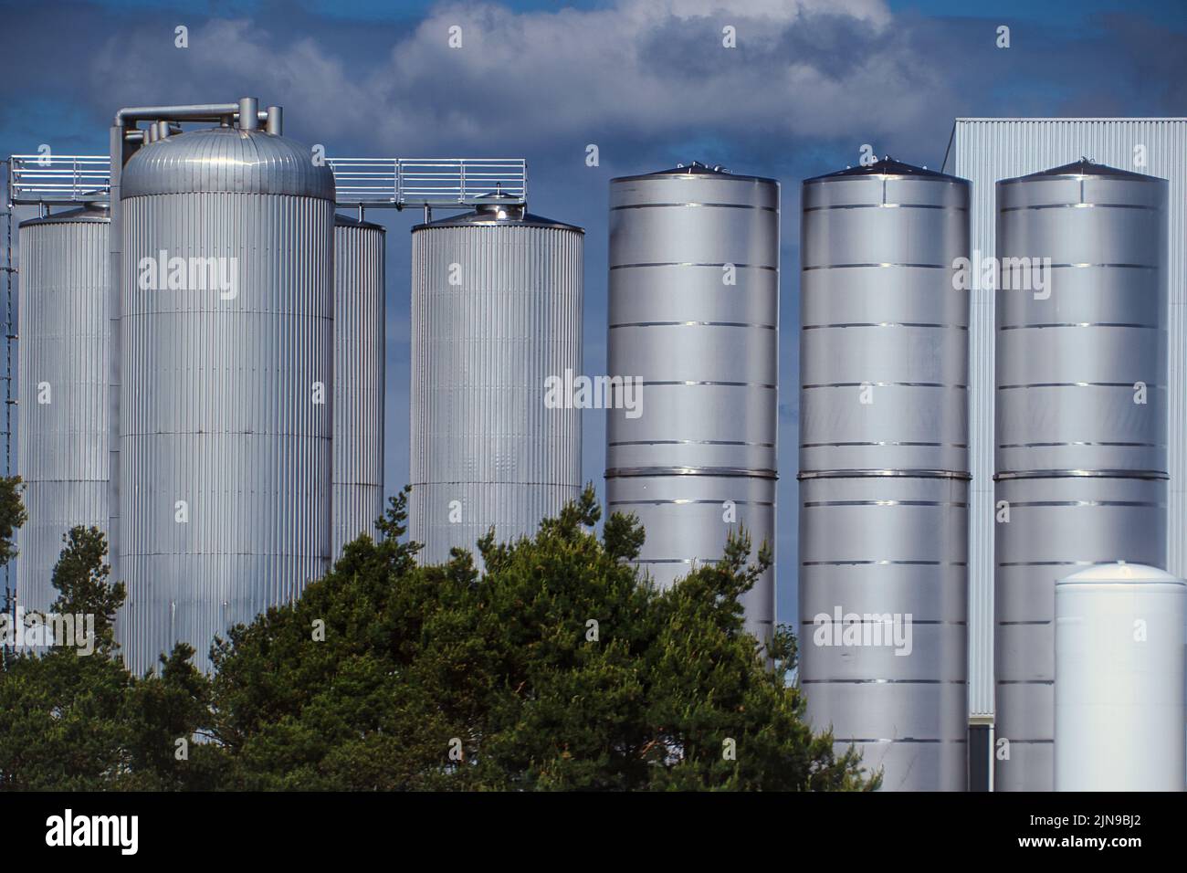 A view of silo towers under blue bright sky Stock Photo - Alamy