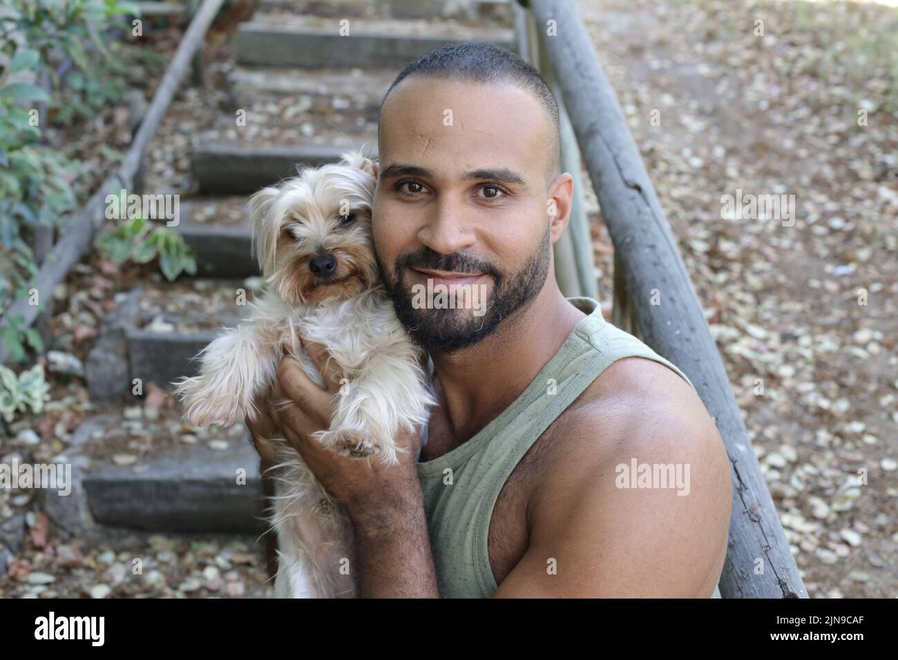Ethnic man and his cute little Yorkshire terrier Stock Photo - Alamy