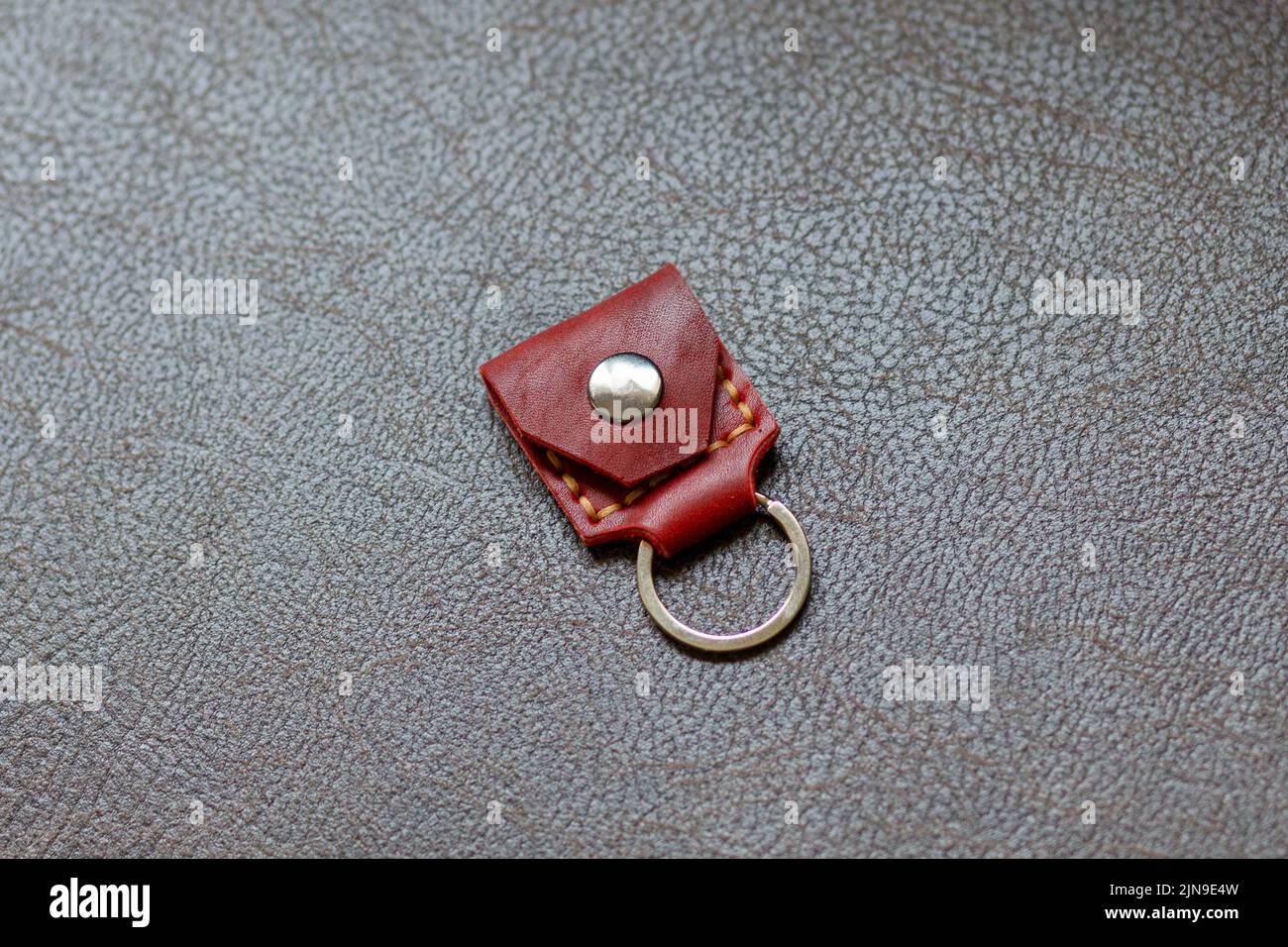 Orange leather key strap with iron ring for mounting on a belt on a ...
