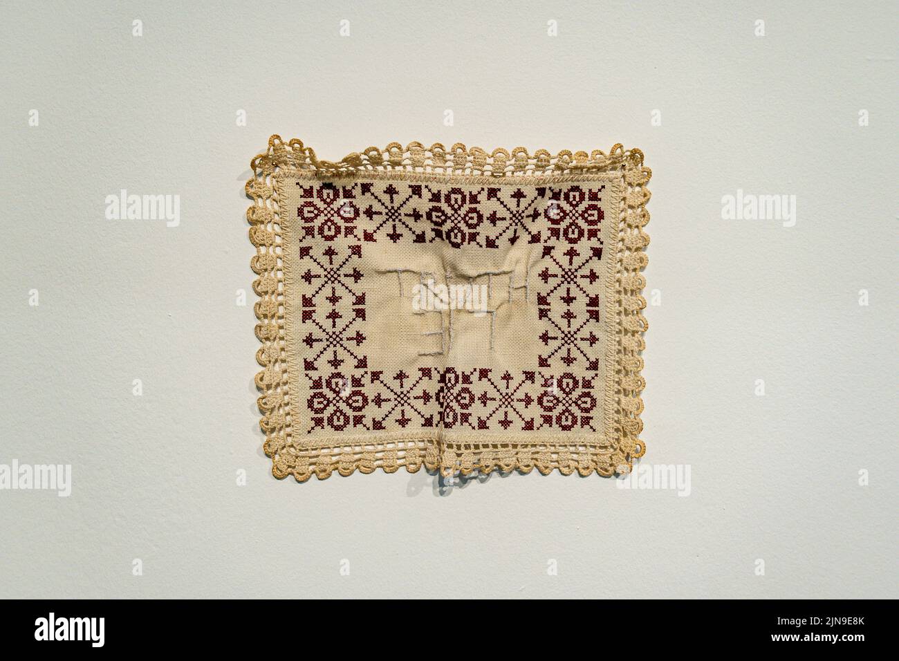 A closeup of a vintage handmade handkerchief on a white background ...