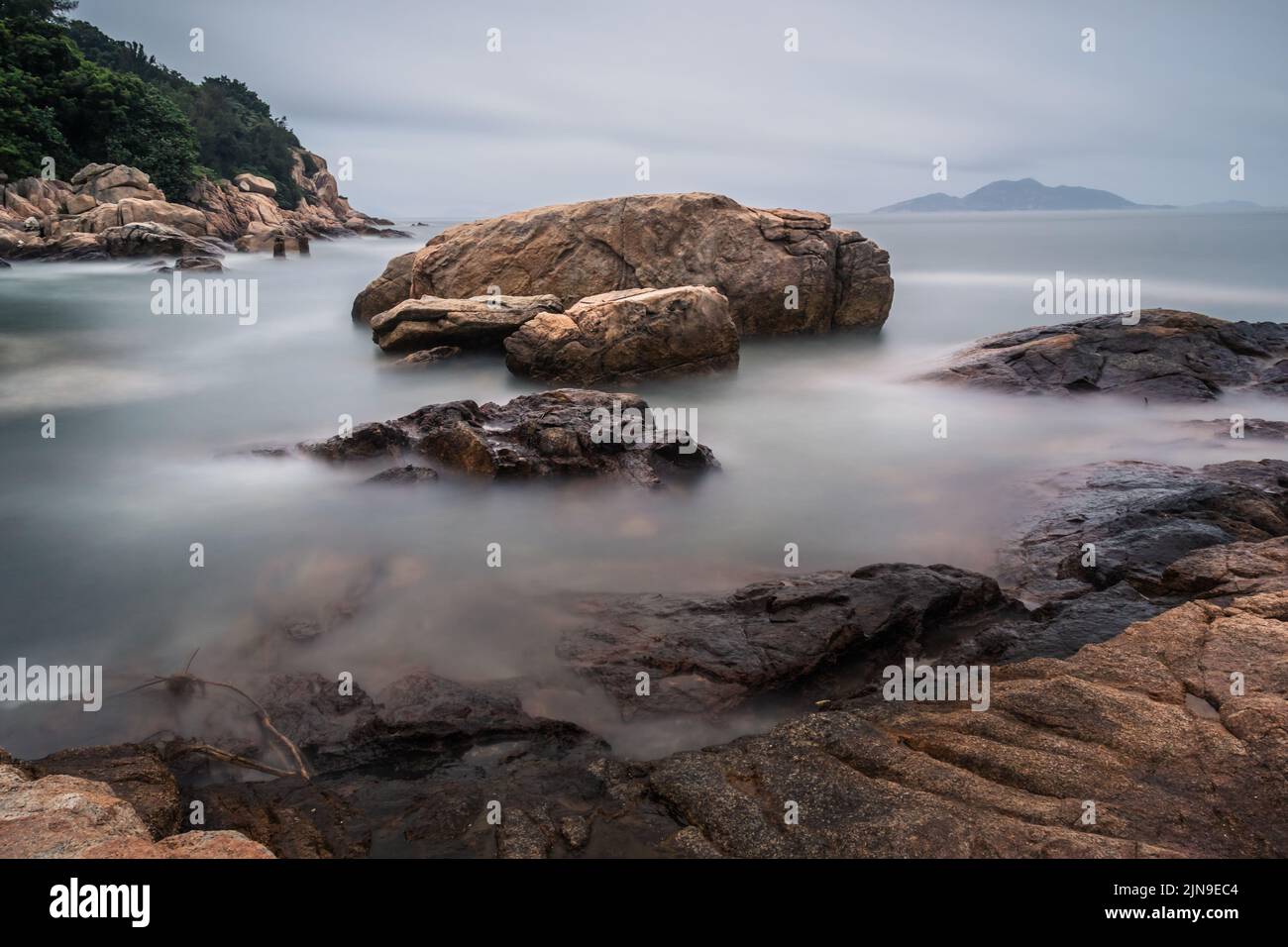 Silky smooth sea around rocks with a long exposure Stock Photo - Alamy