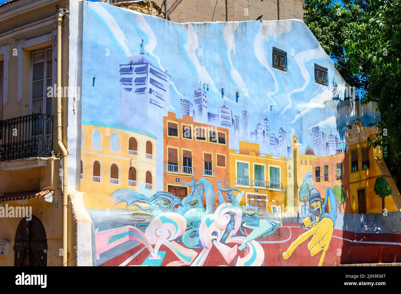A beautiful mural painted in the wall of an old building. The urban art ...