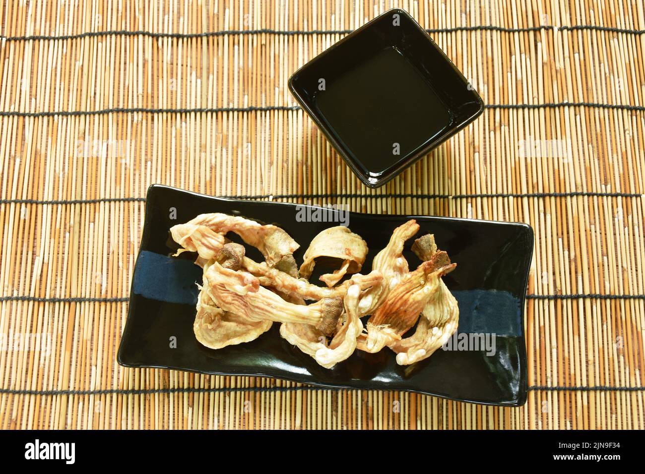 crispy fried duck innards on plate dipping with sweet black soy sauce ...