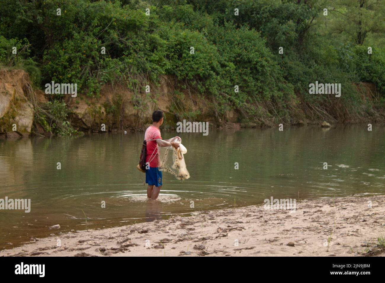 fisherman fishing in small rivers in asia Stock Photo - Alamy