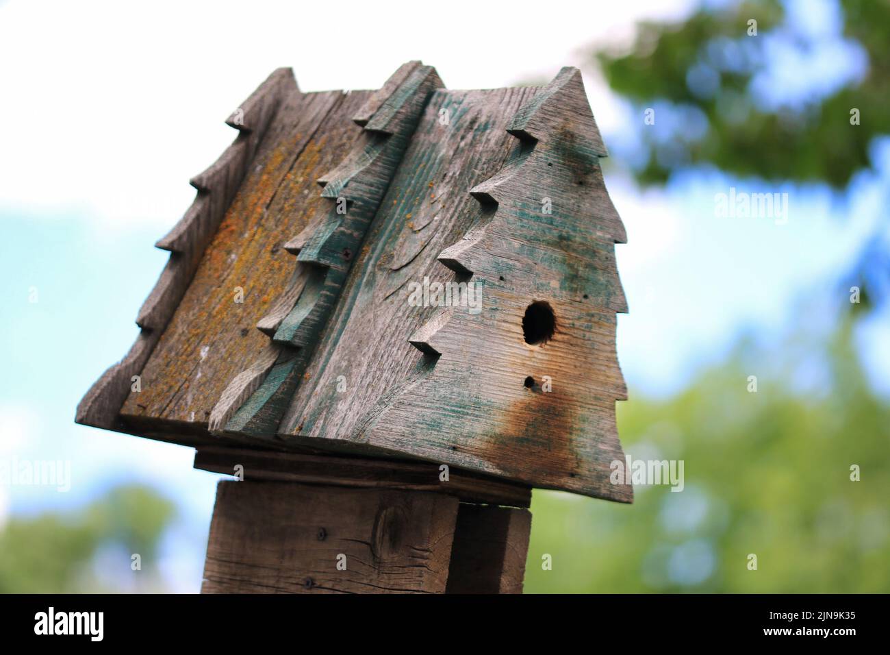 Wooden birdhouse on a post Stock Photo - Alamy