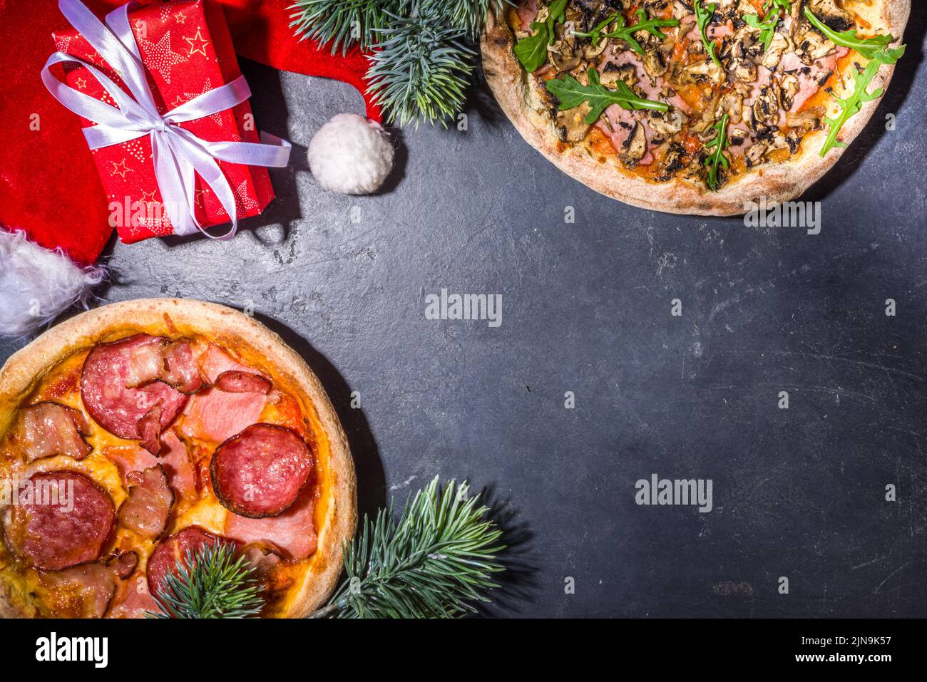 Christmas decorated background with pepperoni and mushrooms pizza ...