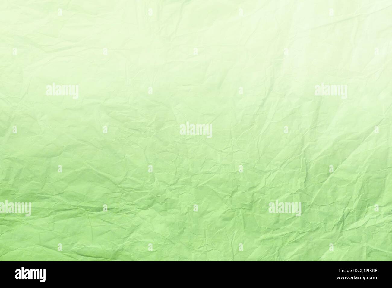 Texture of crumpled light green wrapping paper with gradient, closeup ...