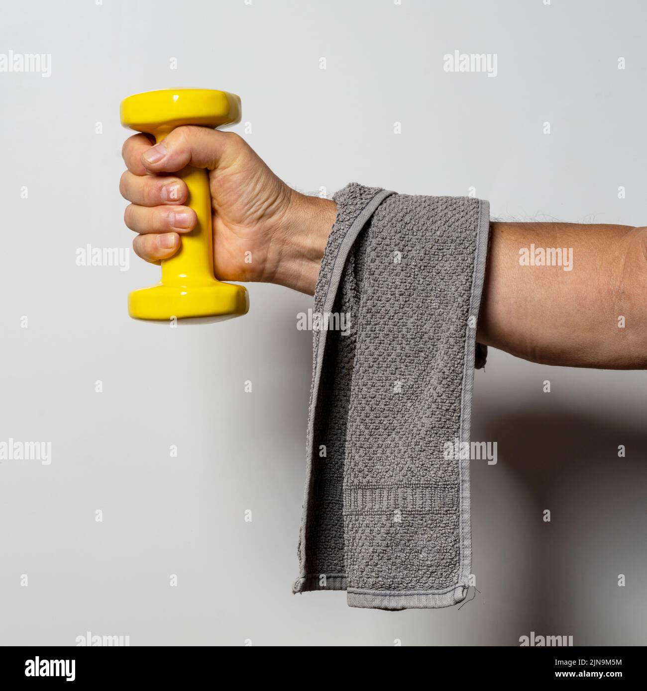 yellow gymnastic weights in hand Stock Photo - Alamy
