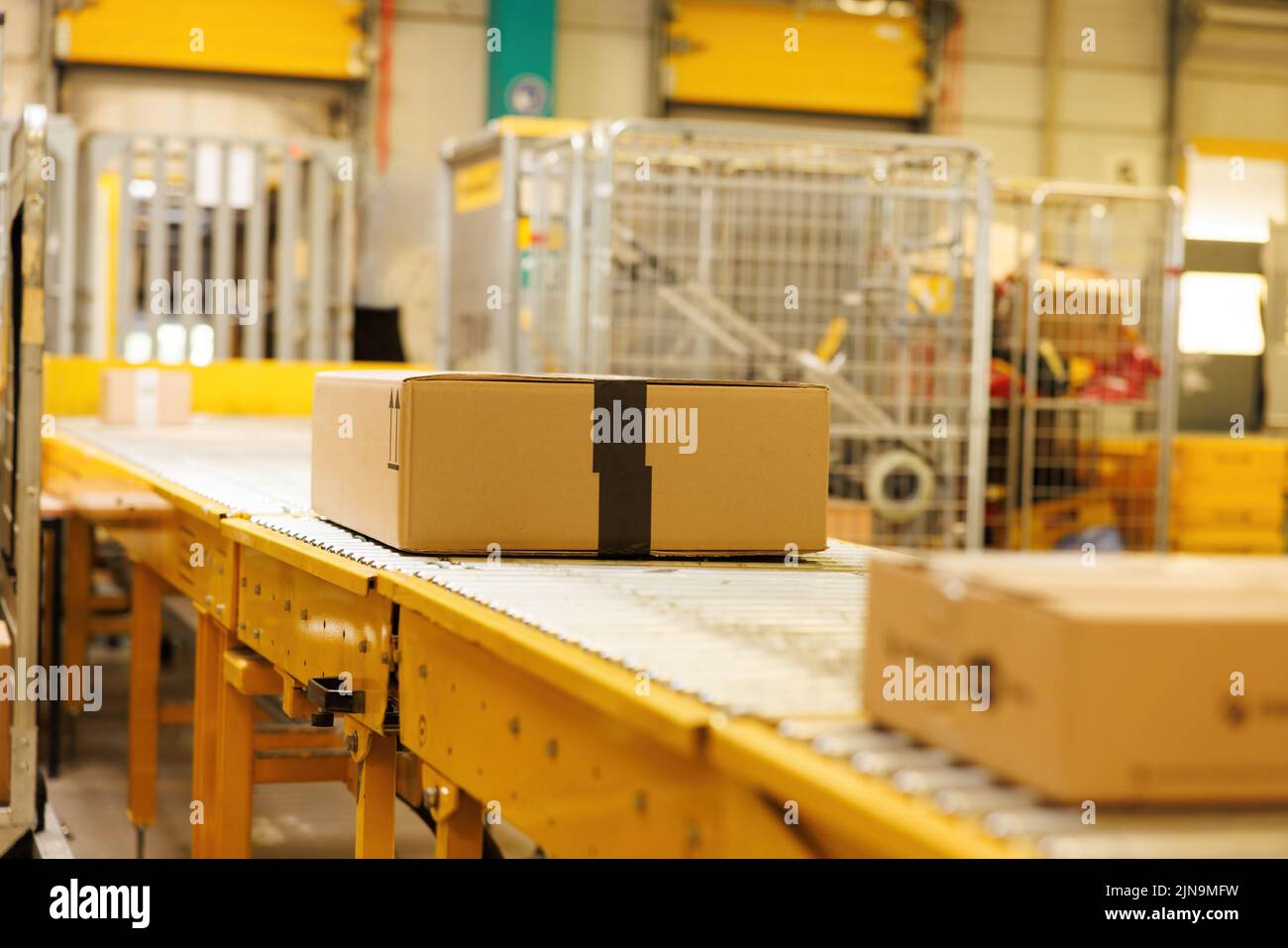 Box on conveyor roller. Delivery service, distribution warehouse and ...
