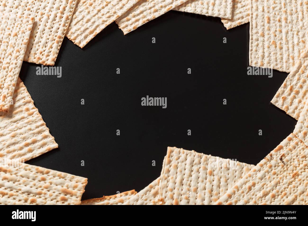 A photo of matzah or matza pieces on black background. Matzah for the ...