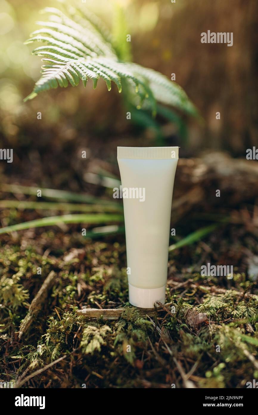 Mockup of a tube for cream on a natural background in the forest, an ...