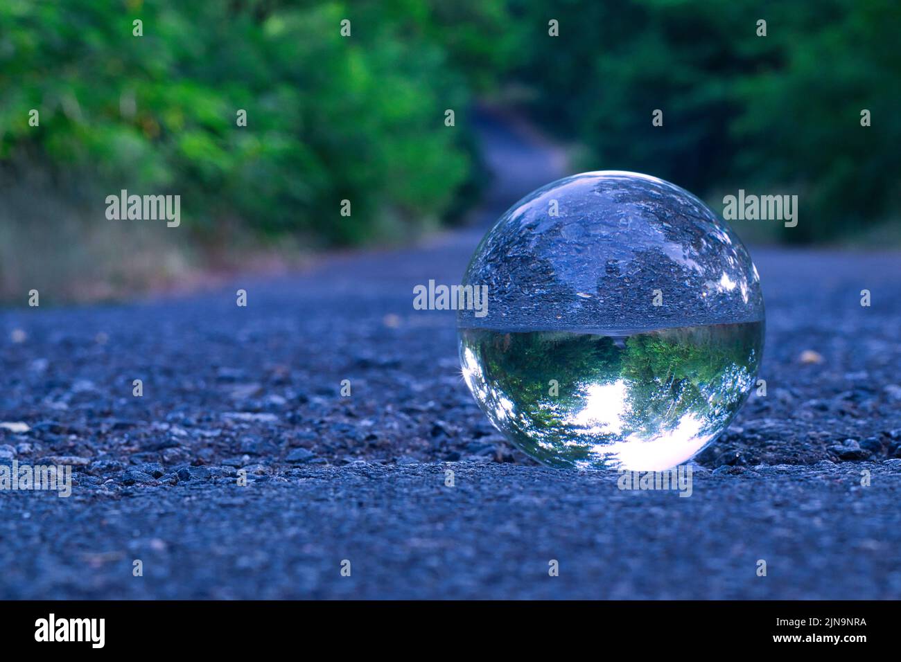 A glass sphere on the ground Stock Photo - Alamy