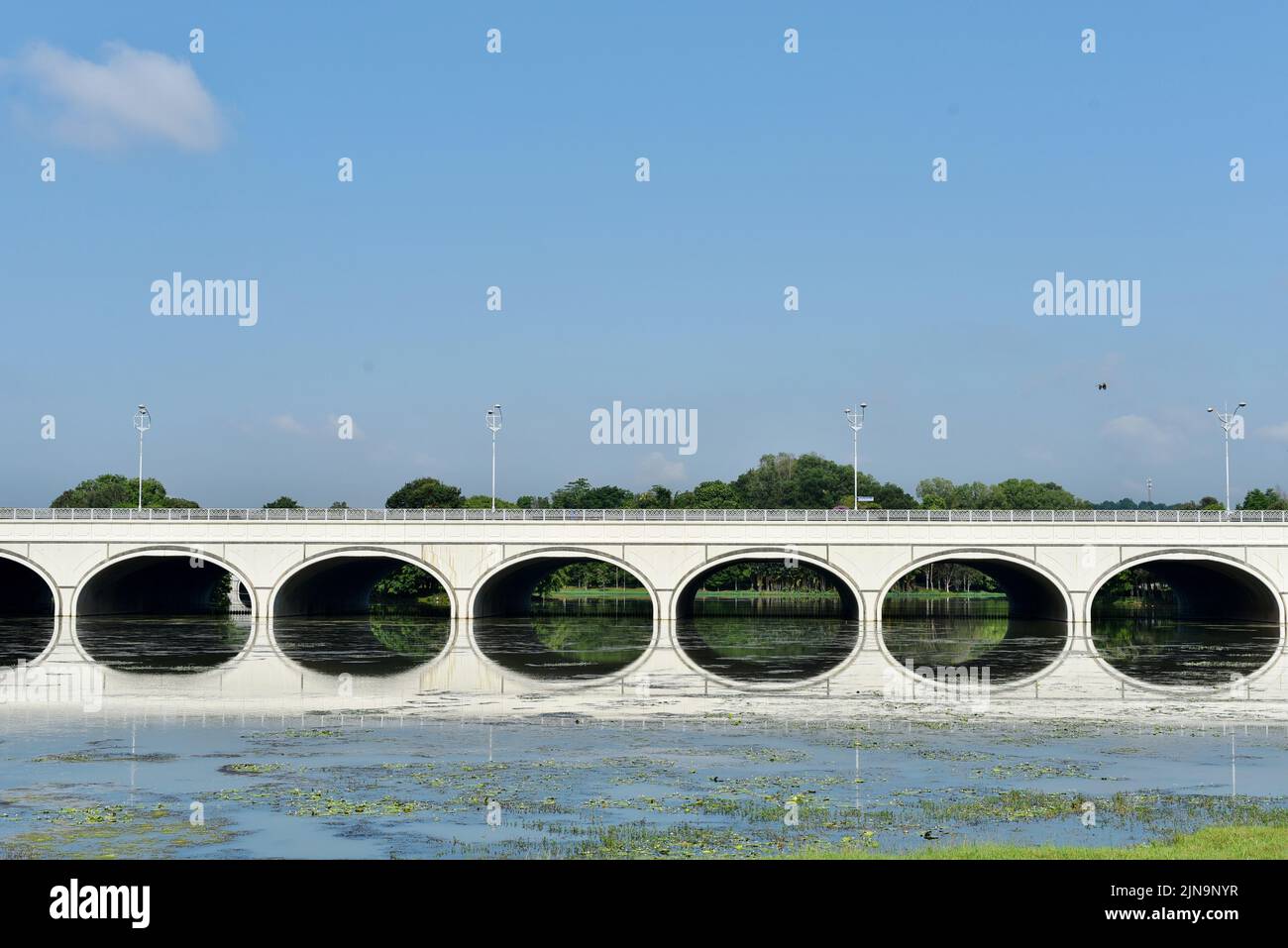 image of a concrete bridge above a lake with reflection. beautiful ...