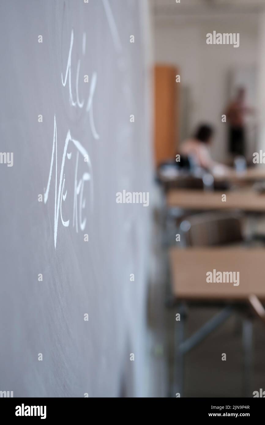 Blackboard with inscriptions made in white chalk, in a classroom ...