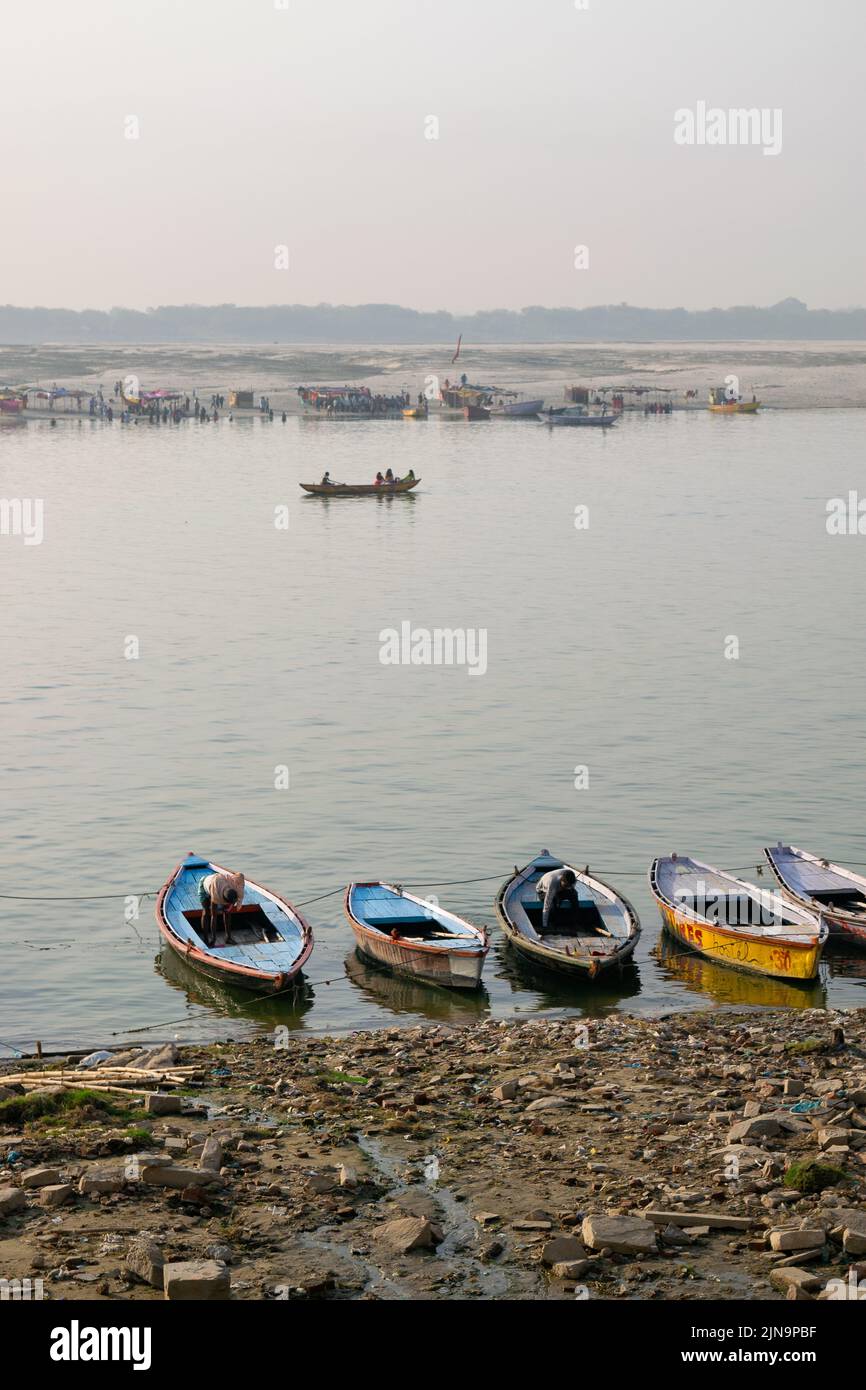 A vertical shot of Varanasi riverfront with skiffs near the shore Stock ...