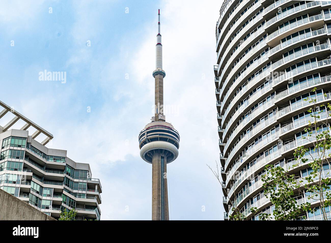 The CN Tower against blue cloudy sky background in Toronto, Ontario ...