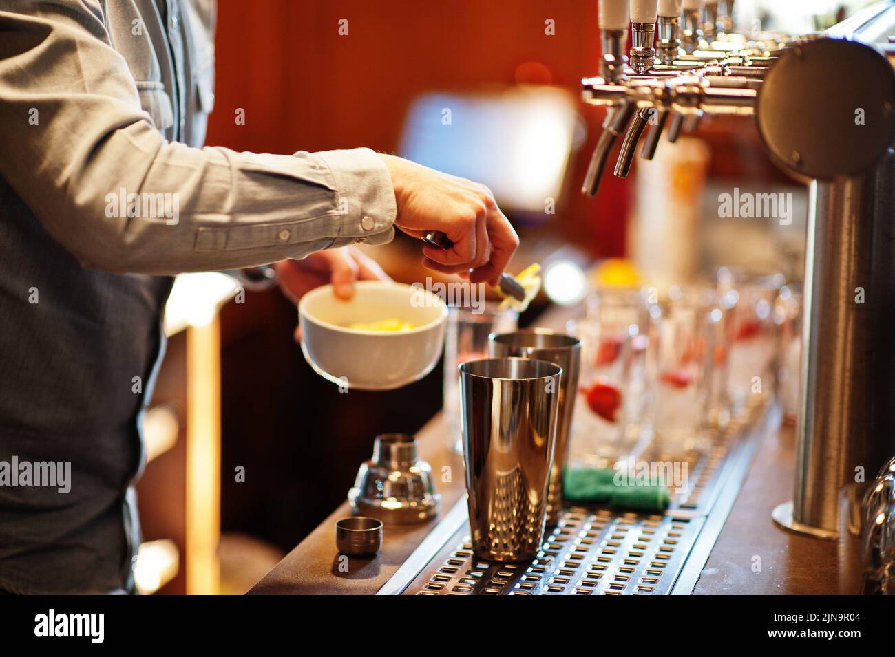 Barman making alcohol cocktail in restaurant Stock Photo - Alamy