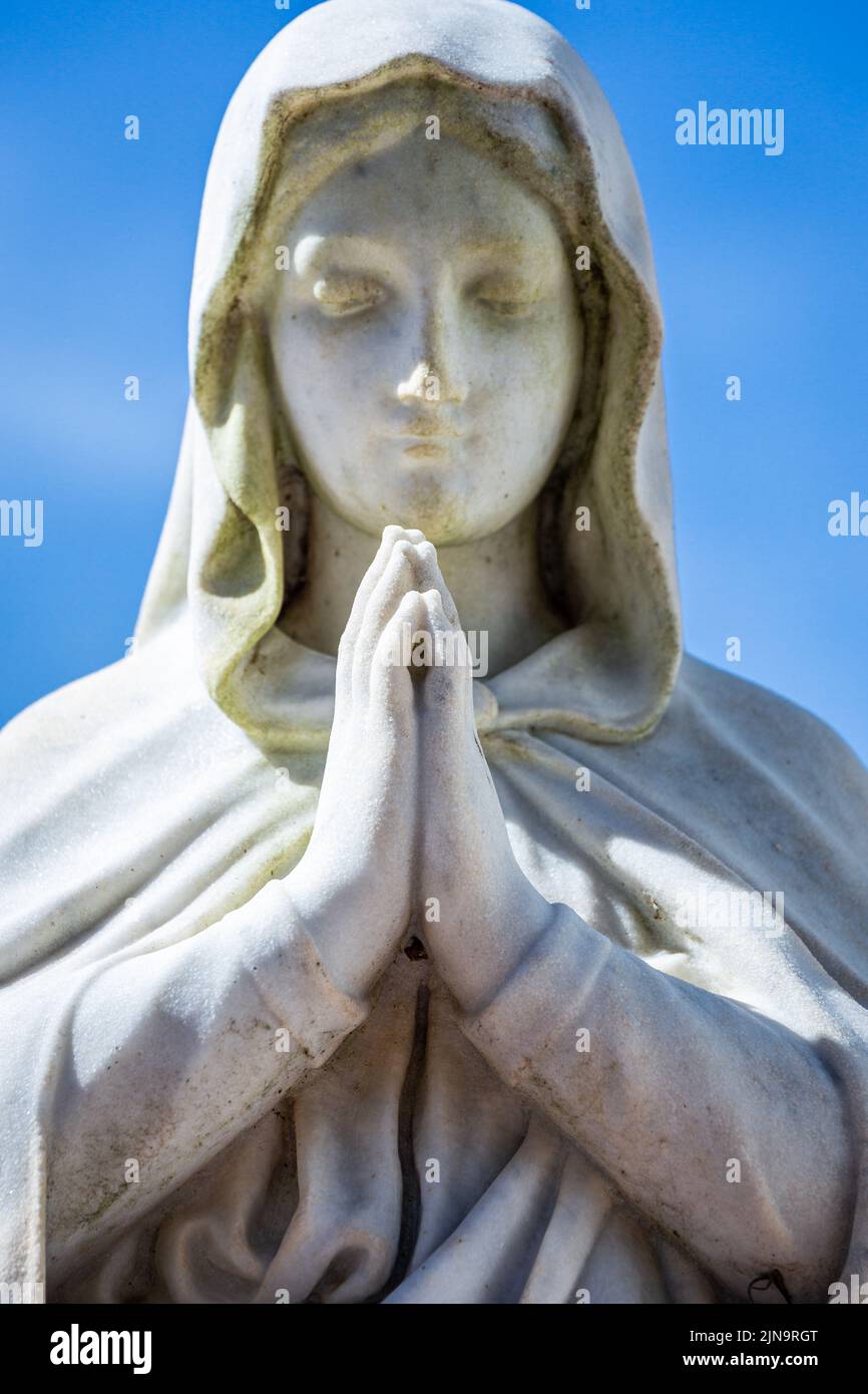 Virgin Mary praying with hands clasped for faith and hope of better ...