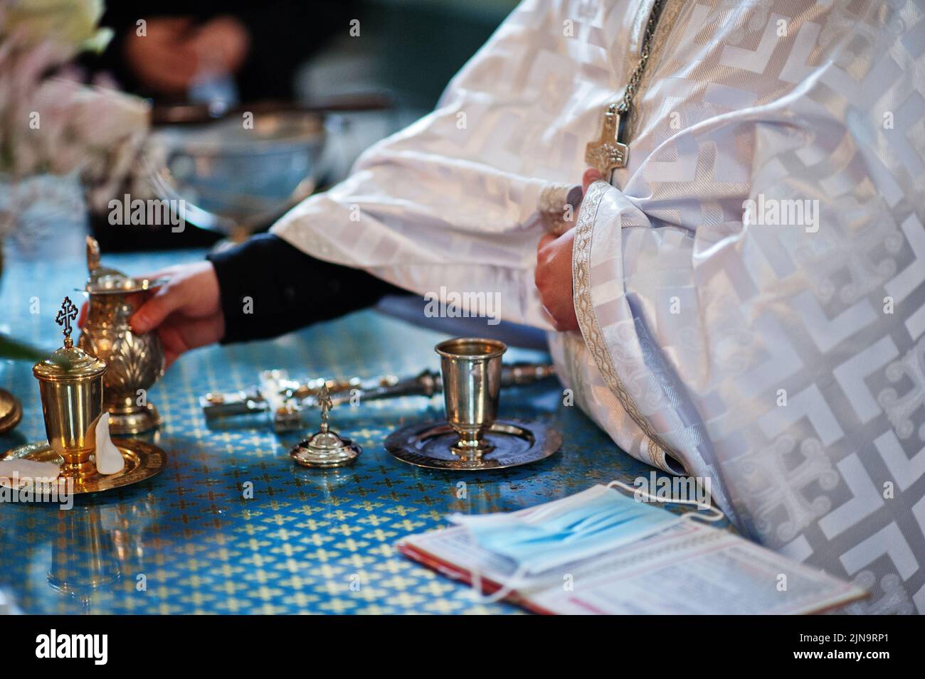 Hand of priest at rite of baptism Stock Photo - Alamy