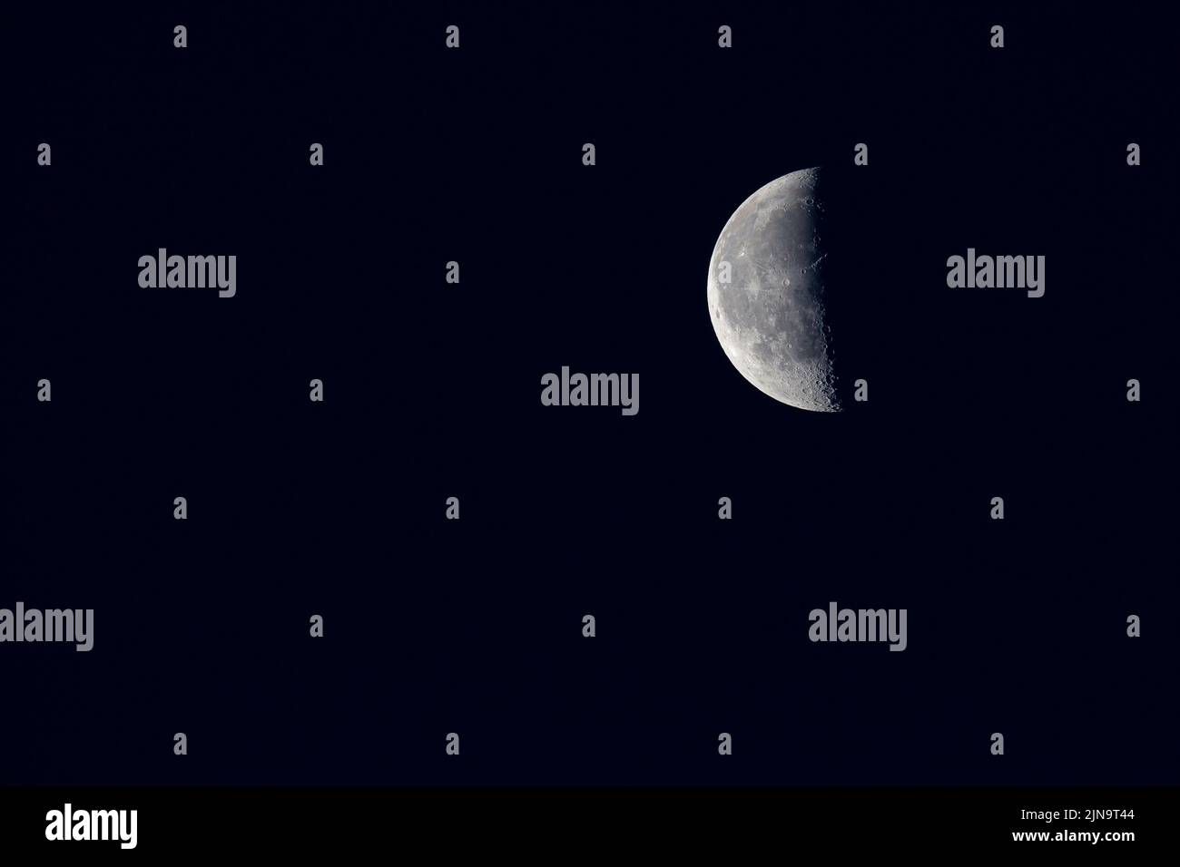 Close up of a half moon (waning third quarter moon) with lots of detail ...