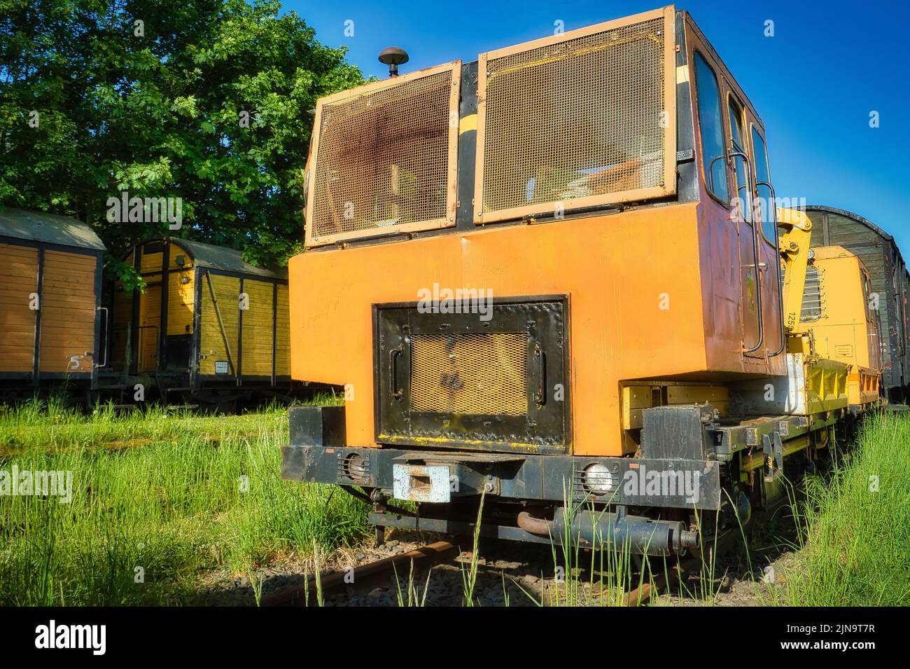 A closeup of an old yellow german locomotive on an abandoned station ...