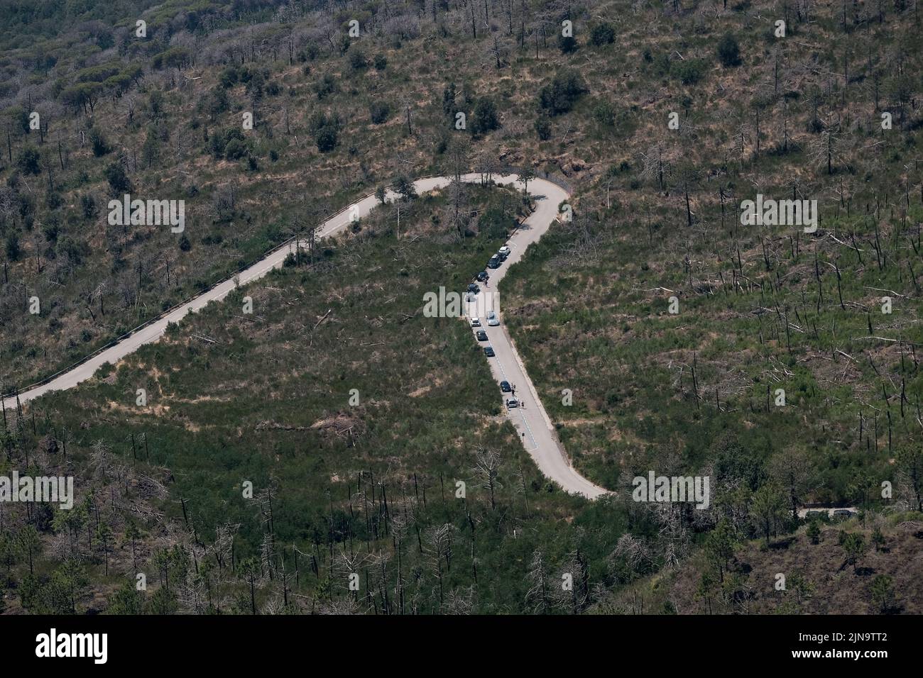 Aerial view of a twisty road and volcanic landscape leading to Mount ...
